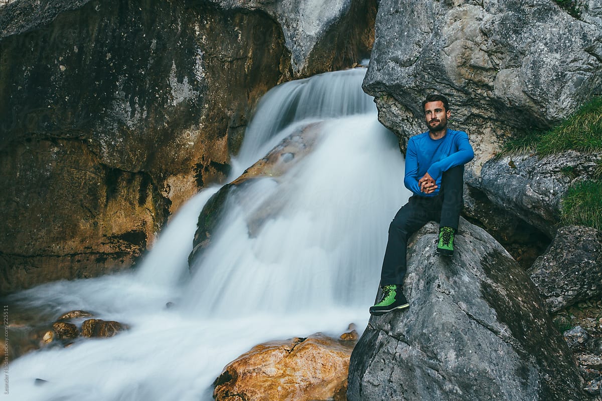 "Young Man Sitting On A Rock Beside A Waterfall" by Stocksy Contributor ...