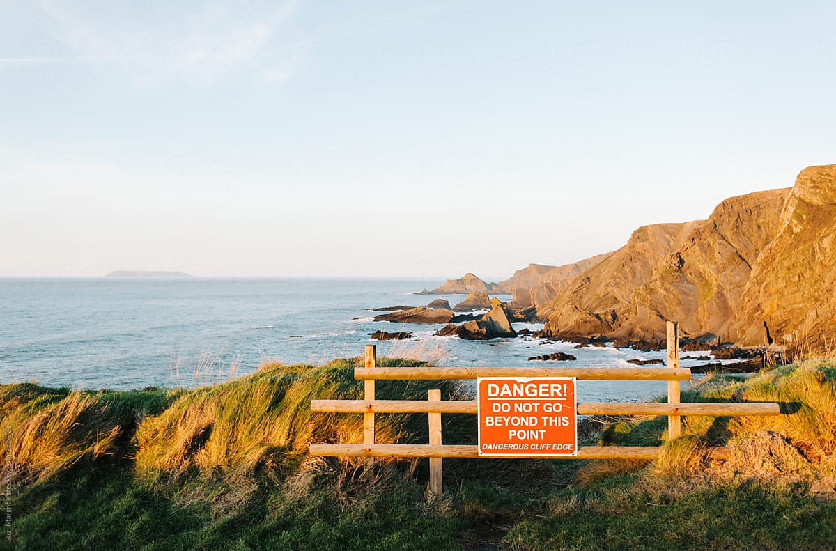 "Warning Sign On A Cliff By The Sea" by Stocksy Contributor "Suzi ...