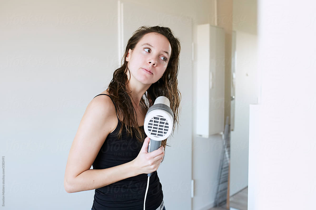 "A Lady Drying Her Hair" by Stocksy Contributor "Emotion Matters" - Stocksy
