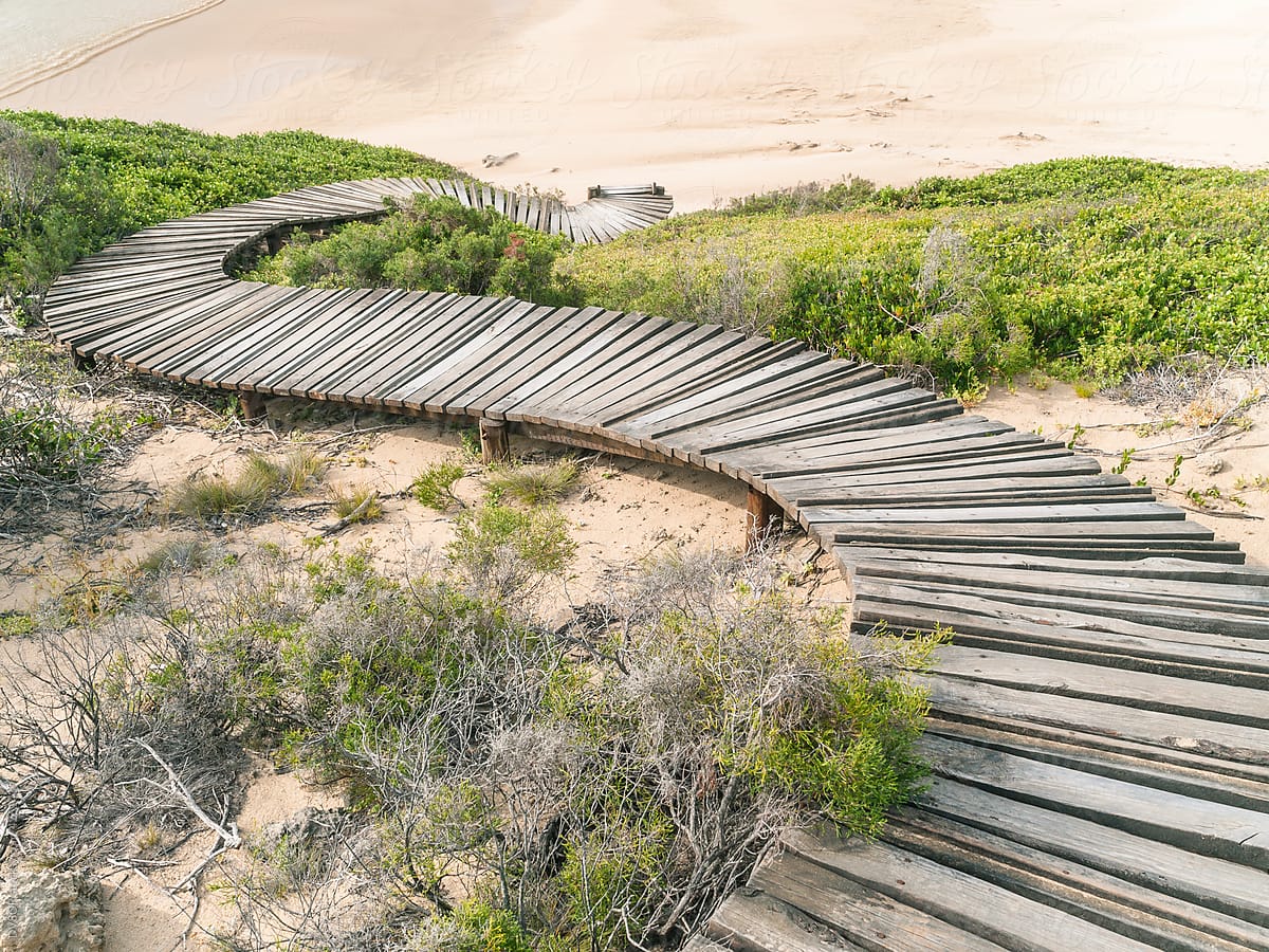 "Winding Wooden Walkway Leading To A Sandy Beach" by Stocksy ...