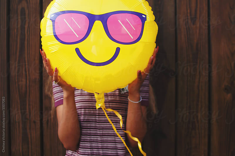 A woman holding a cute balloon - Stock Image - Everypixel