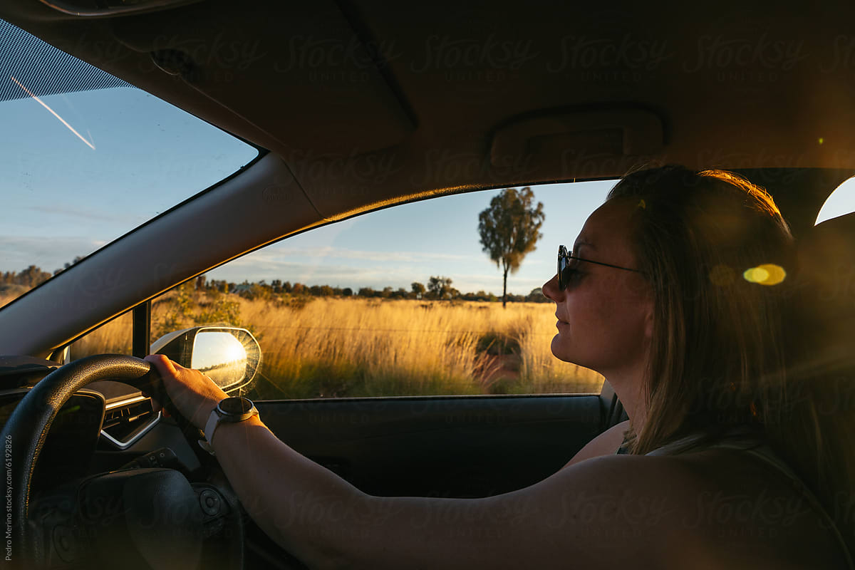 "Side View Of A Young Blonde Woman Driving A Car At Sunset" by Stocksy ...