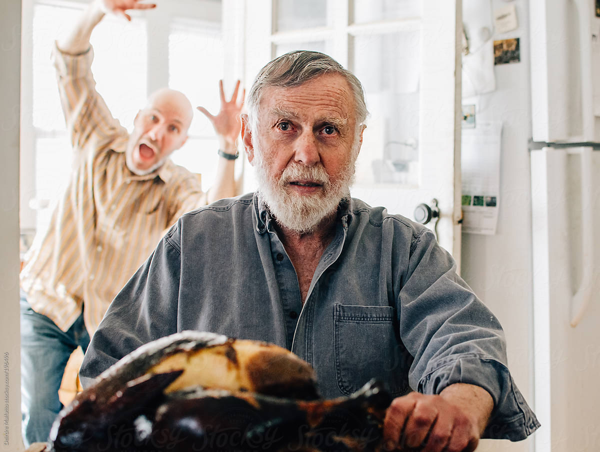 "Man Photobombs Another Man Who Is Carving A Turkey" by Stocksy ...