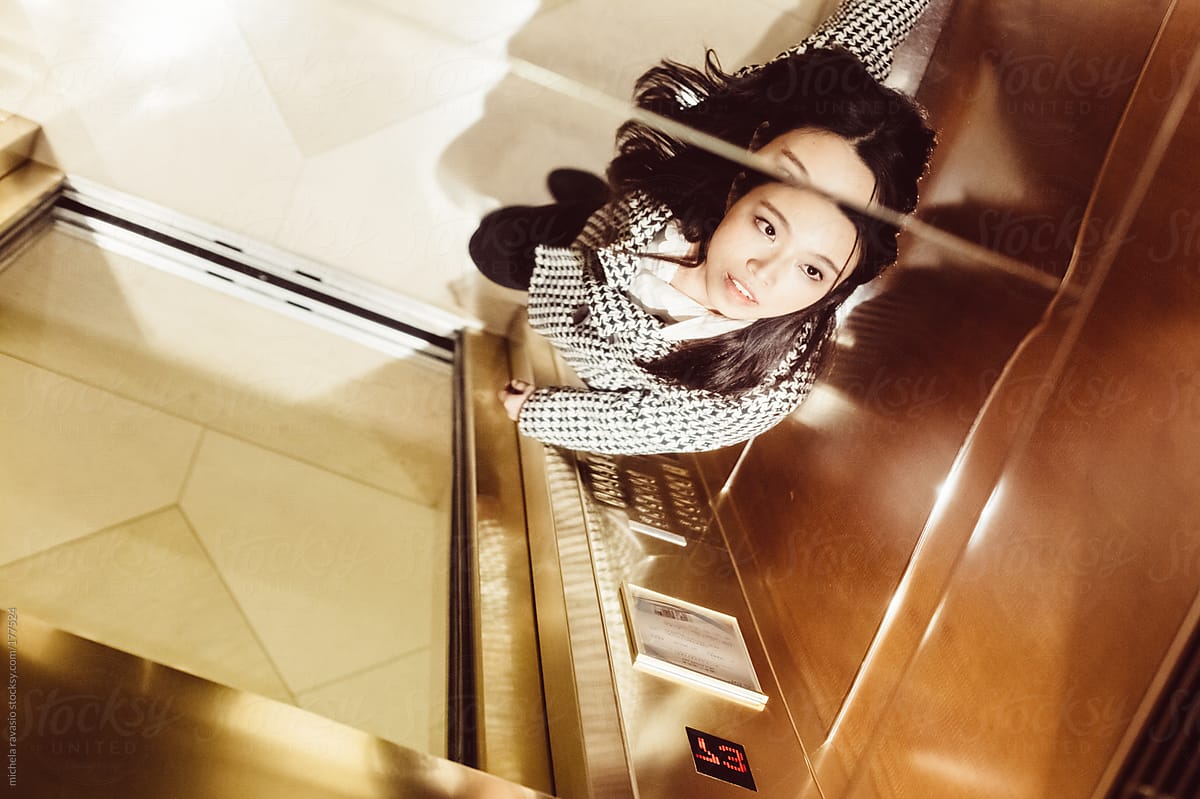 "Young Asian Woman In The Lift" by Stocksy Contributor "Michela Ravasio ...