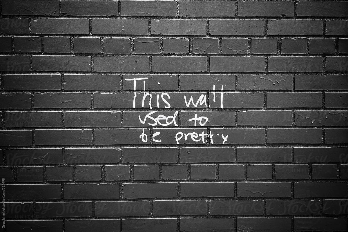 "Writing On A Black Brick Building Wall In A City" by Stocksy ...