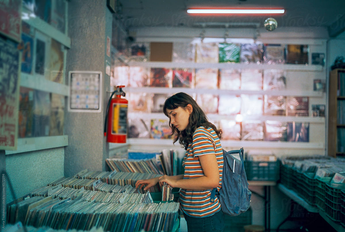 "Woman In Record Store" by Stocksy Contributor "Anna Tsukanova" - Stocksy