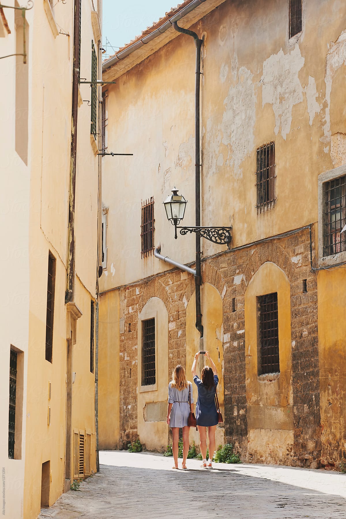 "Two Girl Friends Photograph Architecture Buildings With Smart Ph" by ...