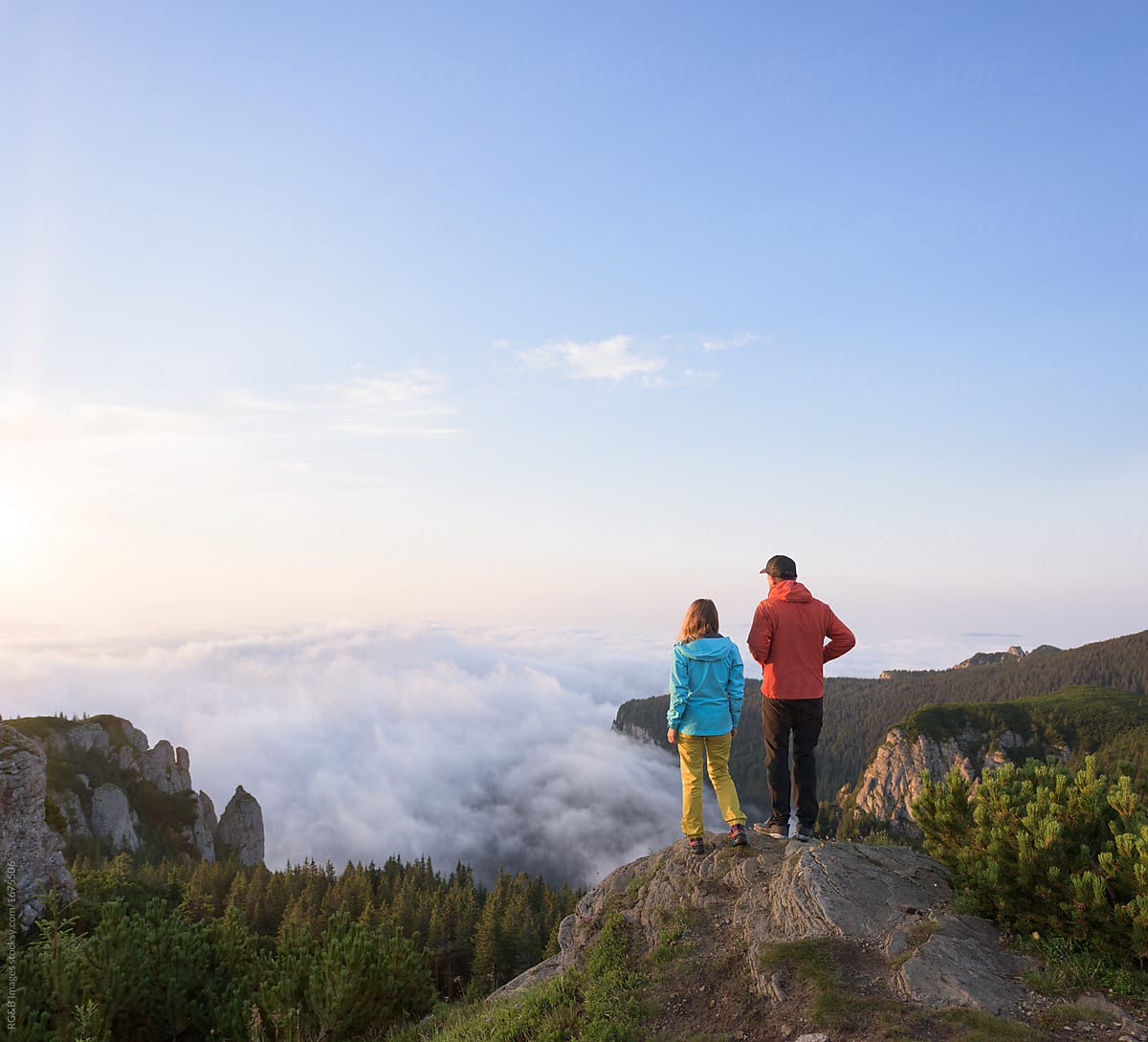  Hikers On Top Of A Cliff Contemplating The Natural Landscape By
