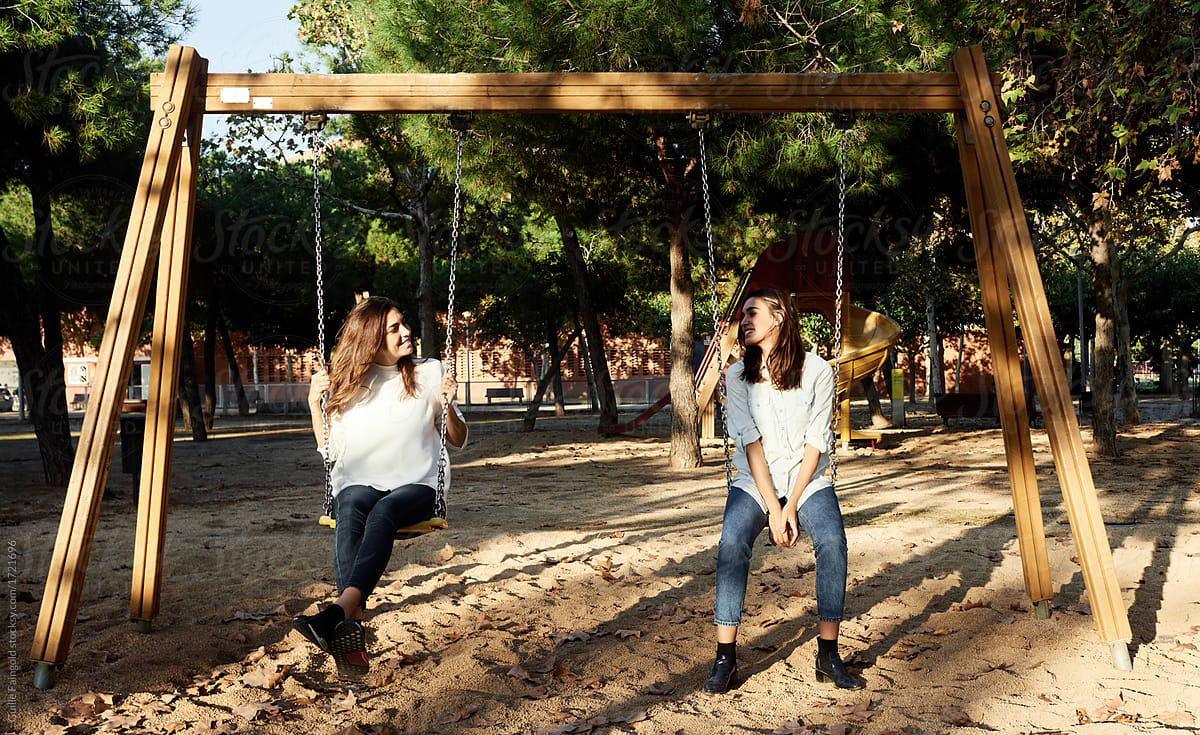 "Cheerful Women On Swings" by Stocksy Contributor "Guille Faingold ...