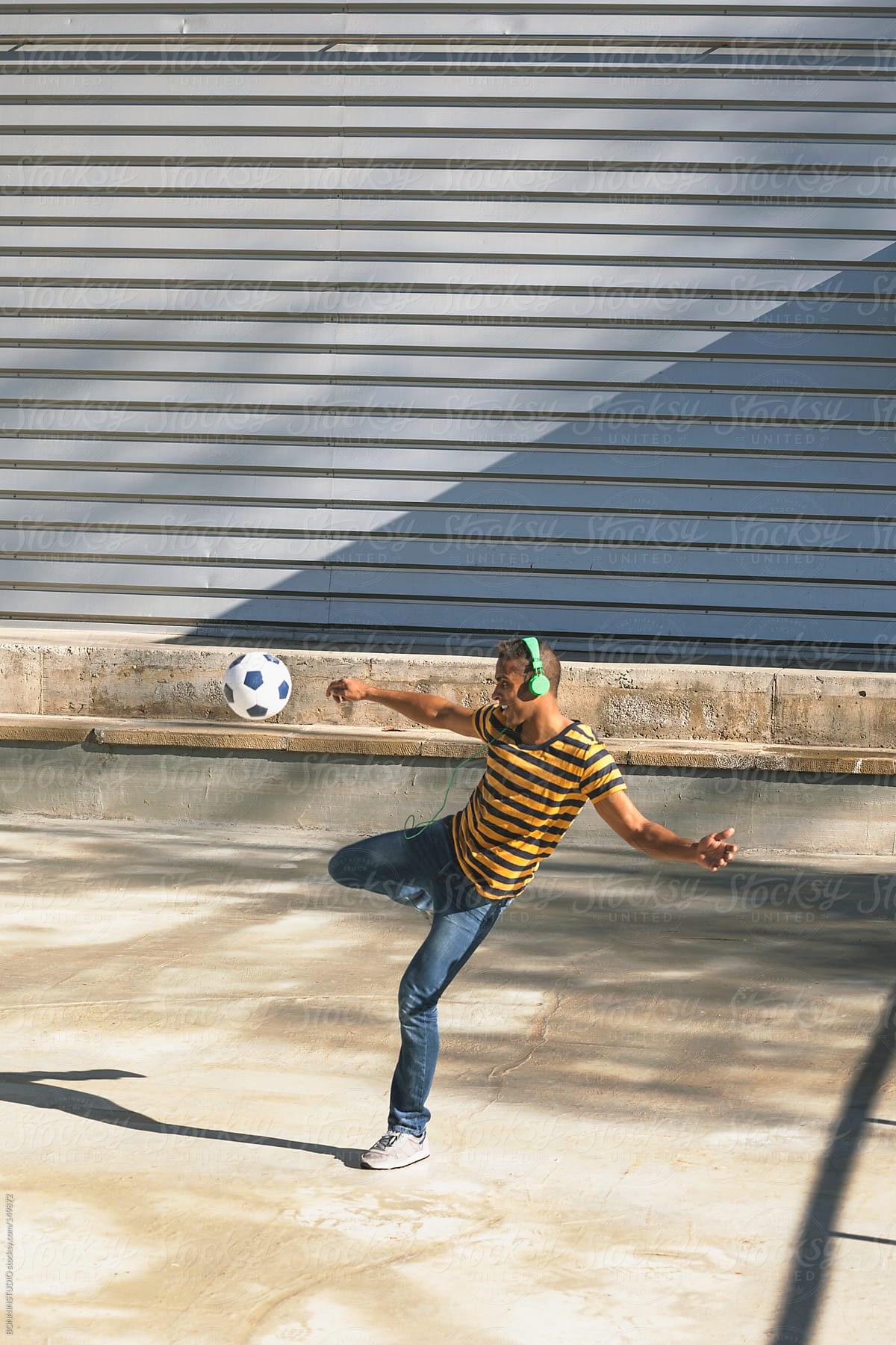 "Black Man Kicking Soccer Ball On Cityscape." by Stocksy Contributor ...