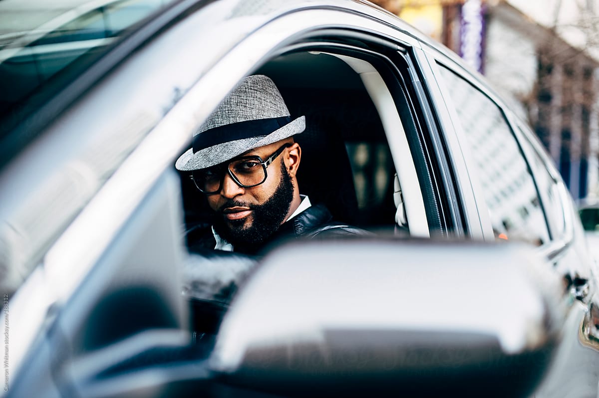 "Stylish Black Man In His Car" by Stocksy Contributor "CWP, LLC" - Stocksy