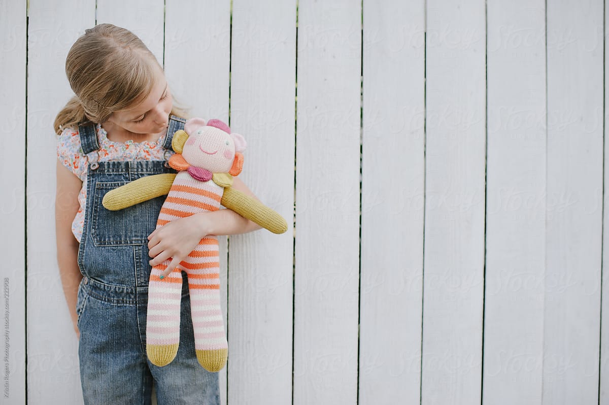 "Young Girl Looking At Her Doll" by Stocksy Contributor "Kristin Rogers ...
