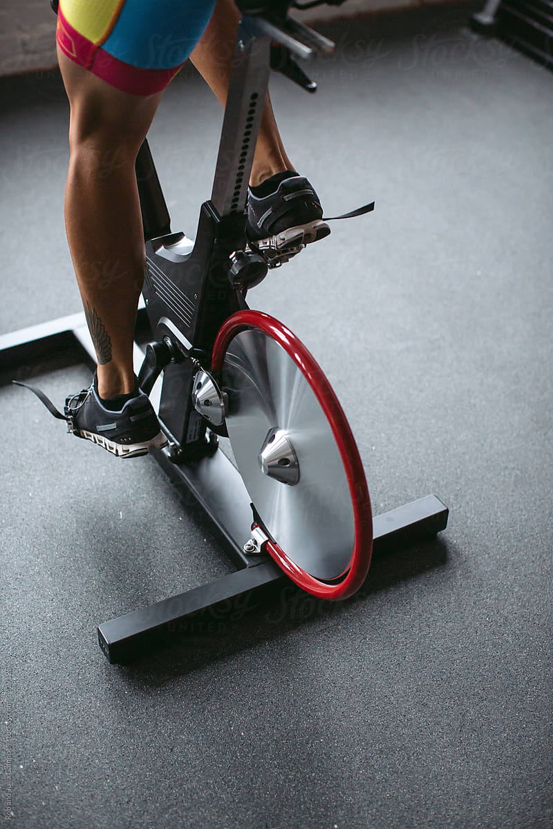 sweaty-young-man-training-on-indoor-stationary-bike-by-stocksy