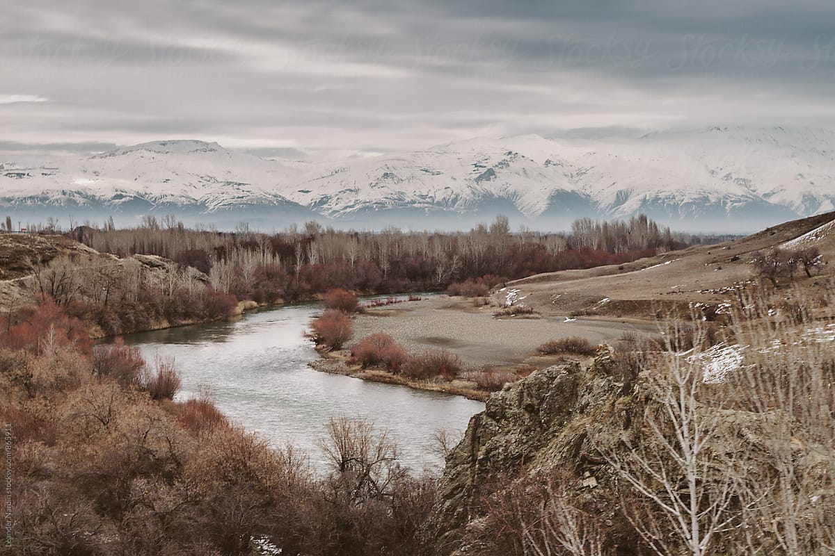 "River Flowing Through Snowcovered Mountain Landscape Surrounded By ...
