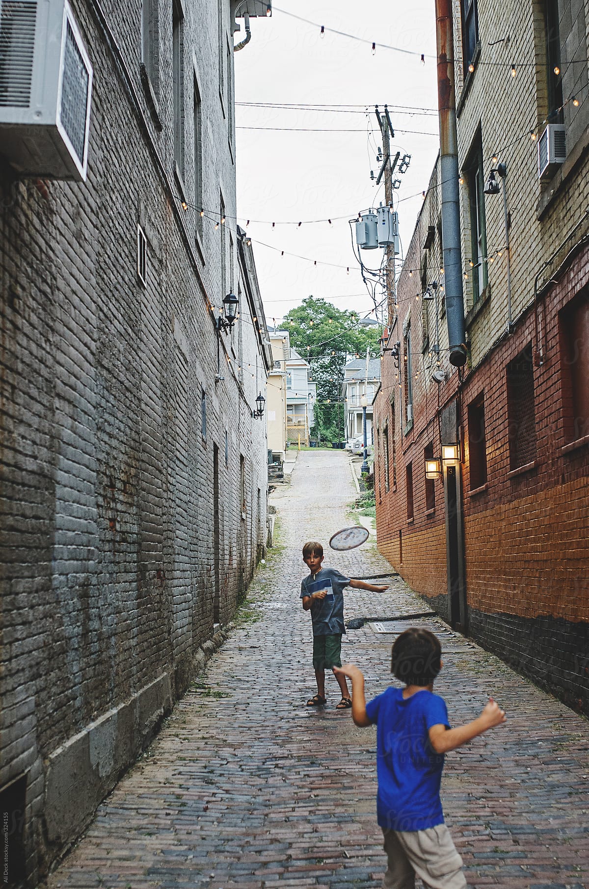 "Frisbee In An Alley" by Stocksy Contributor "Ali Deck" - Stocksy