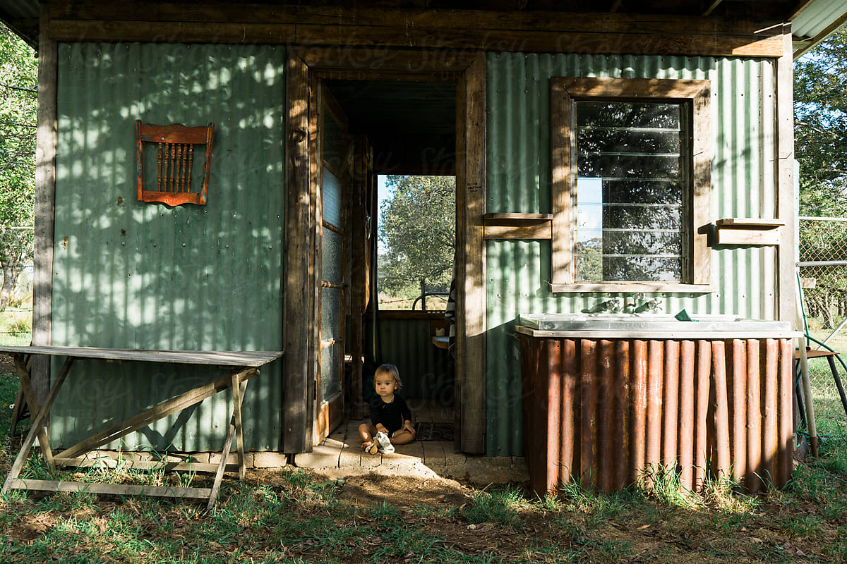 "A Baby Playing Outside A Rustic Shack" by Stocksy Contributor "Gary ...