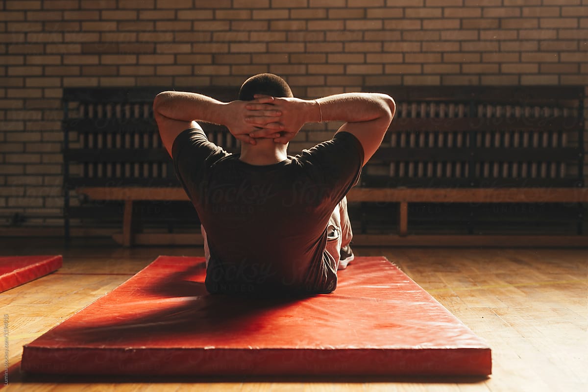 "Man Doing Crunch Exercise" by Stocksy Contributor "Lumina" - Stocksy