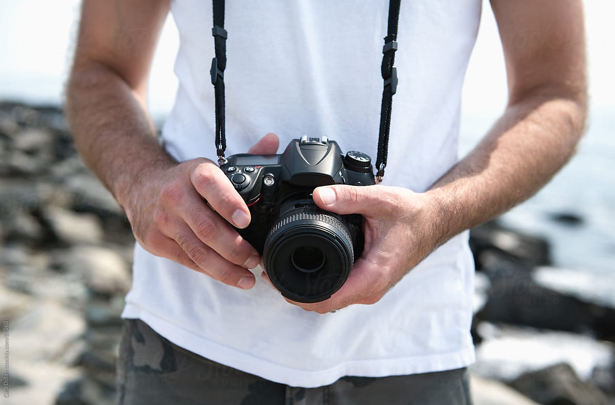 "Anonymous Hands Hold DSLR Camera Outside At The Beach" by Stocksy ...