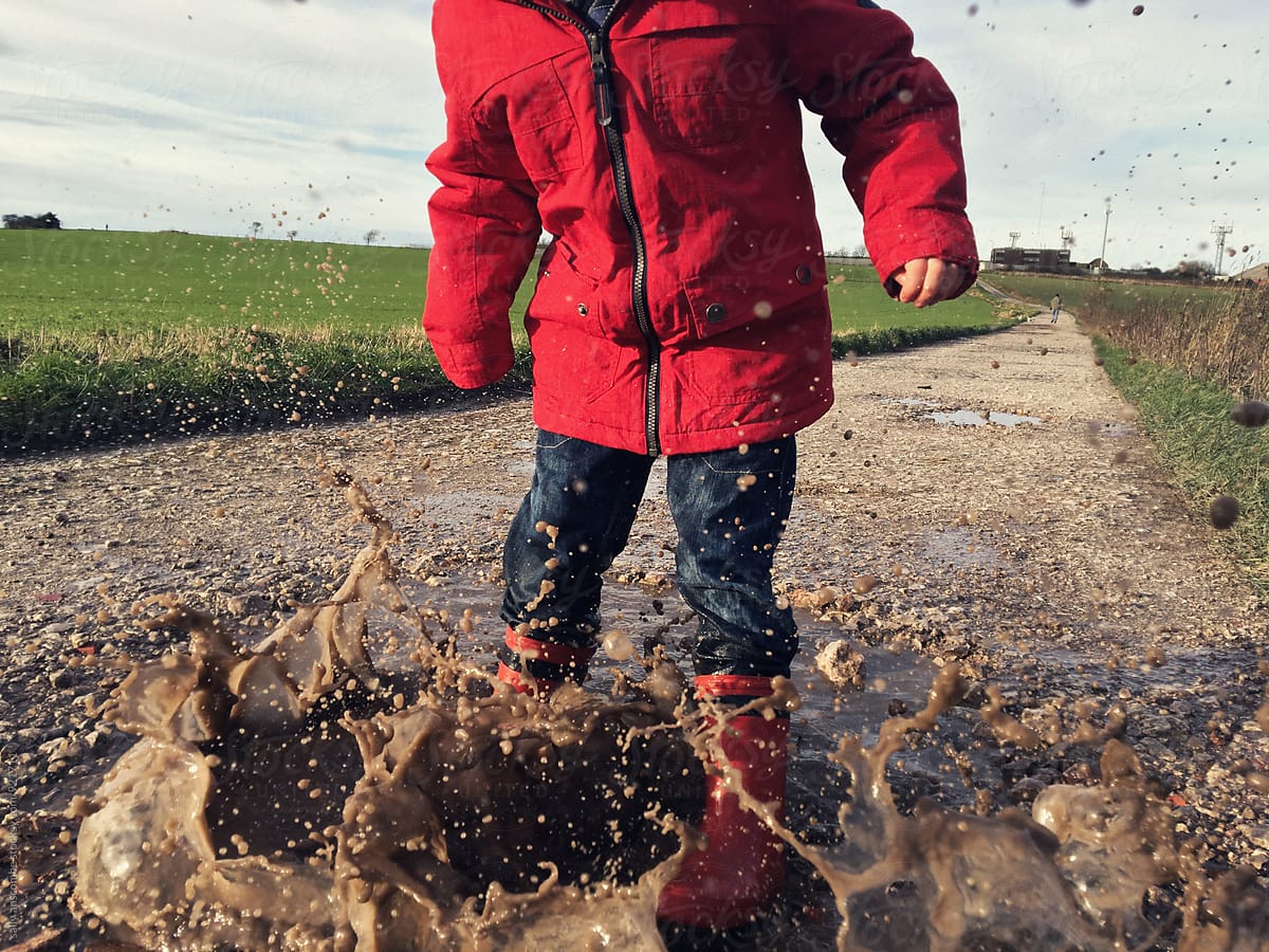 "Child Jumping In A Muddy Puddle" by Stocksy Contributor "Sally ...
