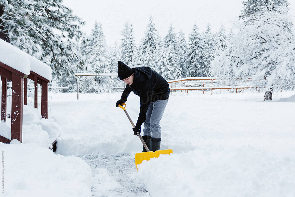 "Man Shoveling Snow" by Stocksy Contributor "Justin Mullet" - Stocksy