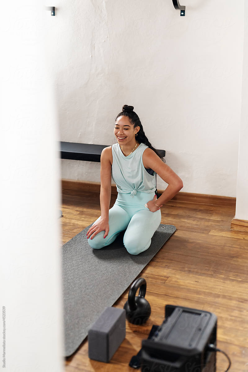 "Fit Woman Sitting On Mat In Gym" by Stocksy Contributor "Studio ...