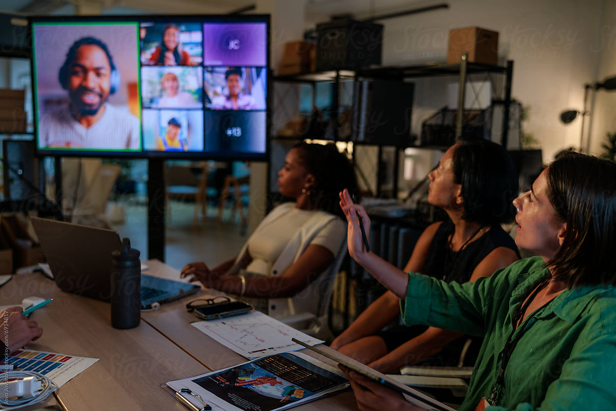 "Team Meeting With Remote Participants On Large Screen At Night" by ...