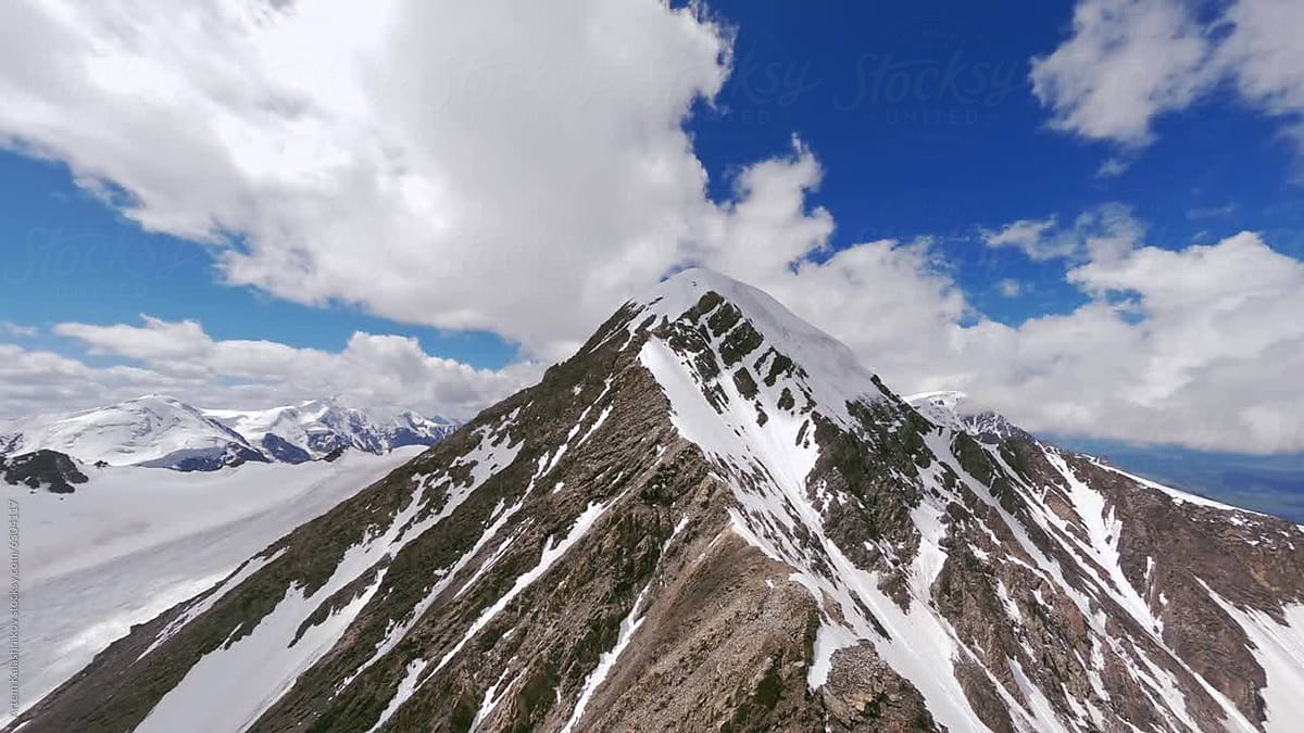 "Snowy Mountain Ridge Summit Aerial View" by Stocksy Contributor "Artem ...
