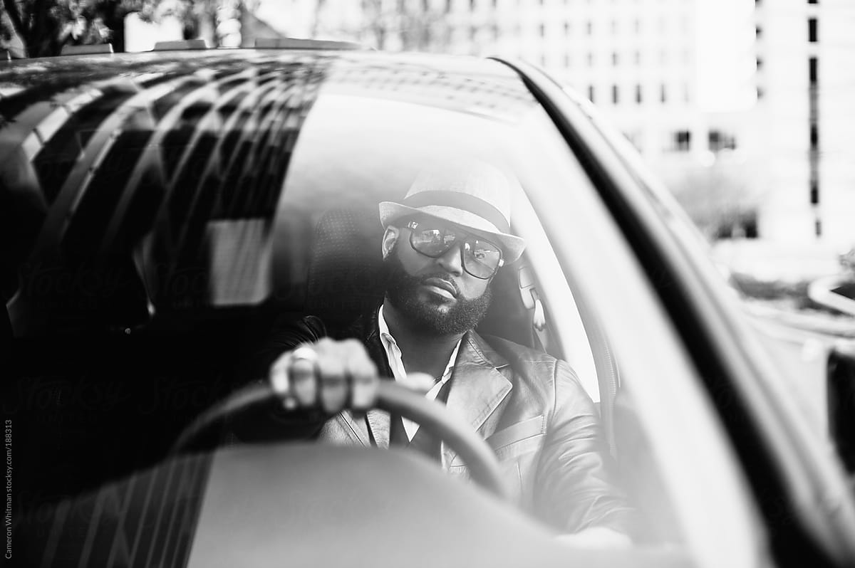 "Stylish Black Man In His Car" by Stocksy Contributor "CWP, LLC" - Stocksy
