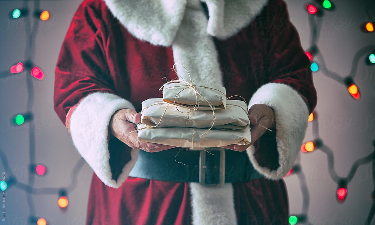 "Santa Claus Holding Stack Of Natural Paper Wrapped Gifts" by Stocksy ...
