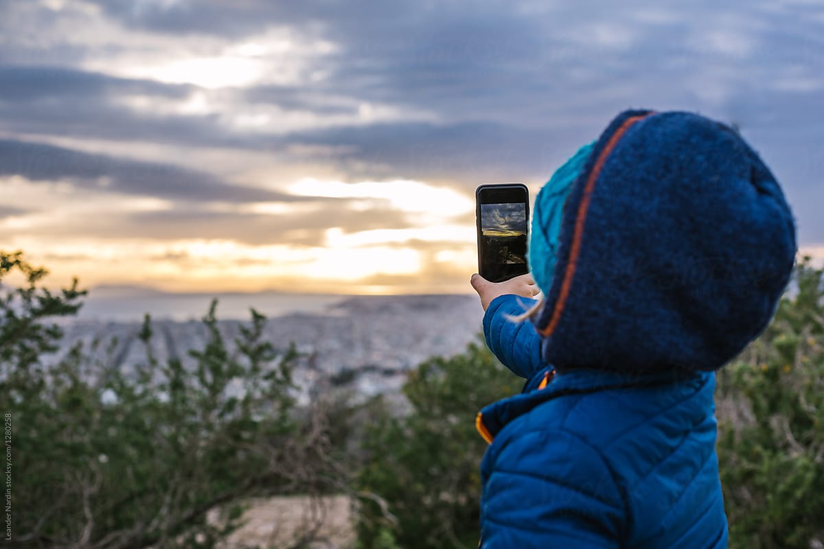 "Little Boy Taking A Photo With A Mobile Phone From The Sunset Above ...