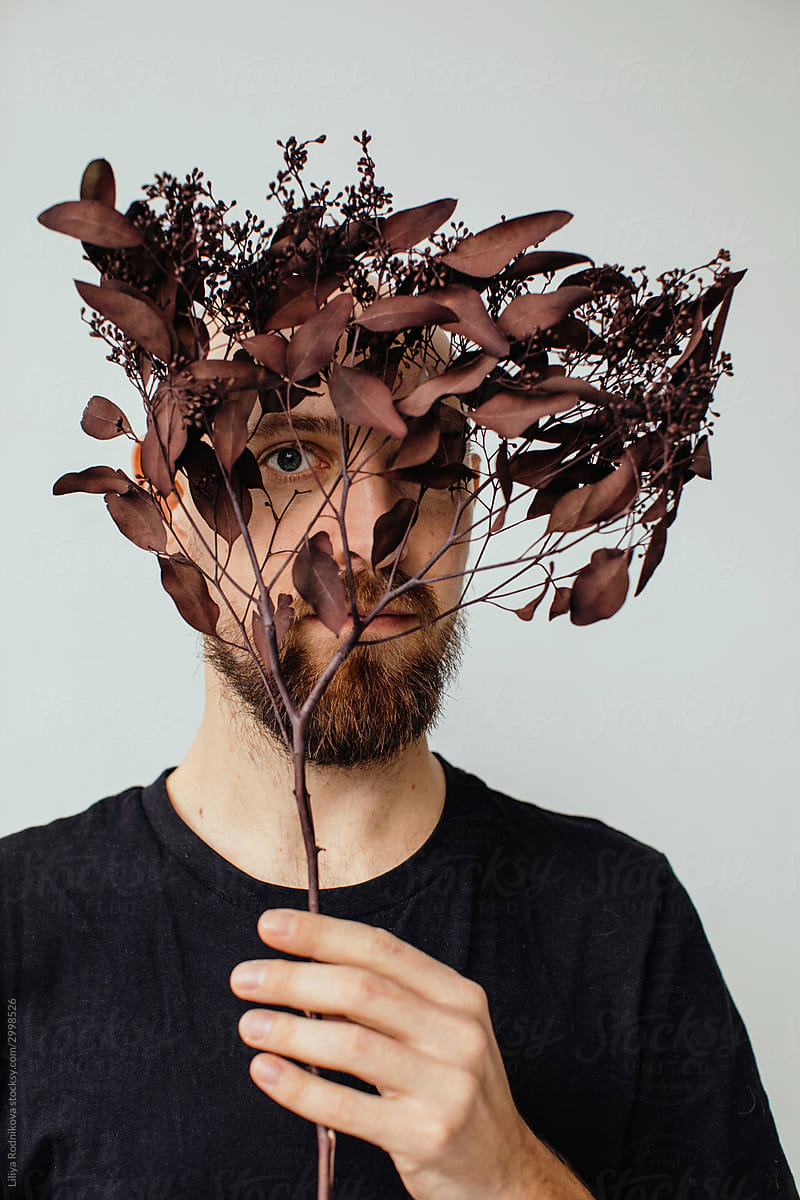 "Portrait Of Man Hiding Face Behind Branch" by Stocksy Contributor ...
