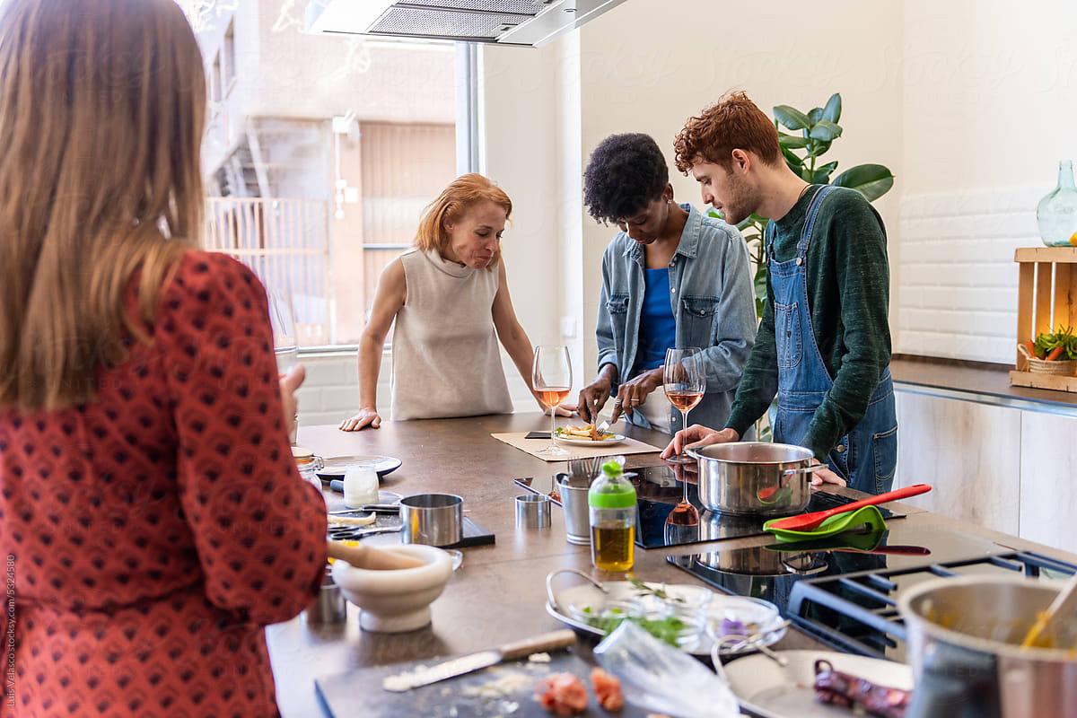 Multiracial Group Of Friends Cooking A Meal Together. - Stock Image ...