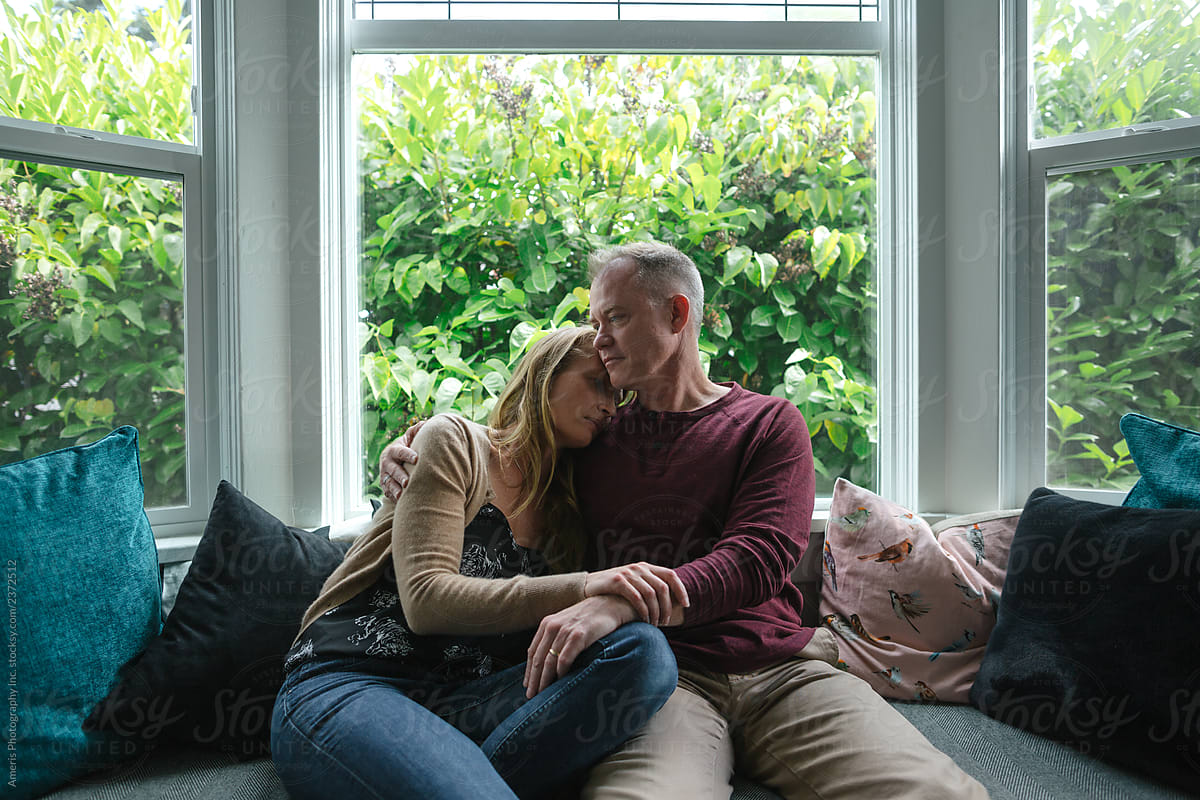 "Serious Couple Hugging Together At Home." by Stocksy Contributor "Rob ...
