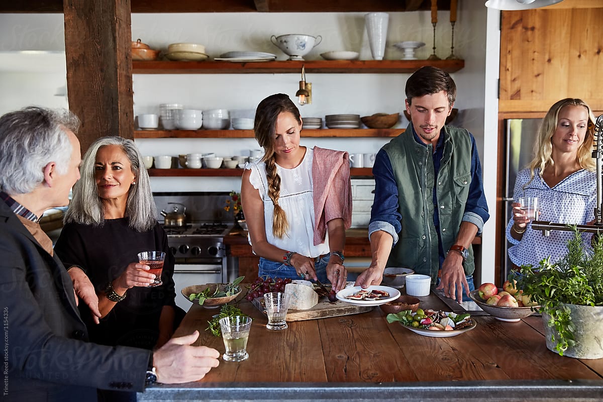 "Family And Friends Cooking Together In Rustic Farmhouse Kitchen" by ...