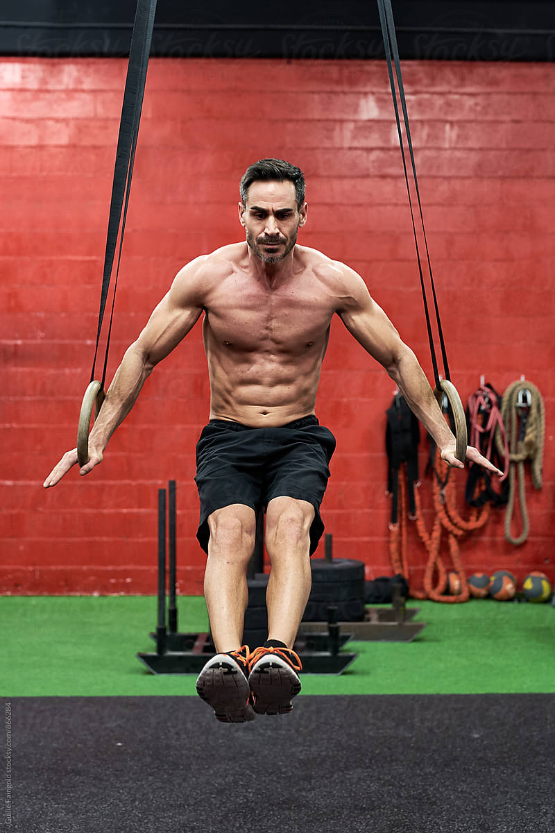 "Muscular Man On Still Rings" by Stocksy Contributor "Guille Faingold ...