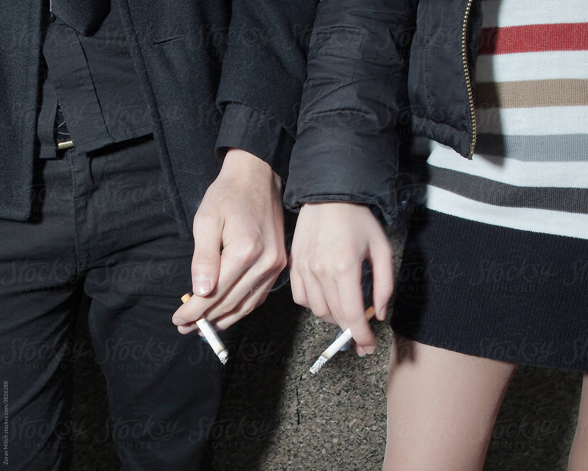 "Couple Smoking" by Stocksy Contributor "Zoran Milich" - Stocksy