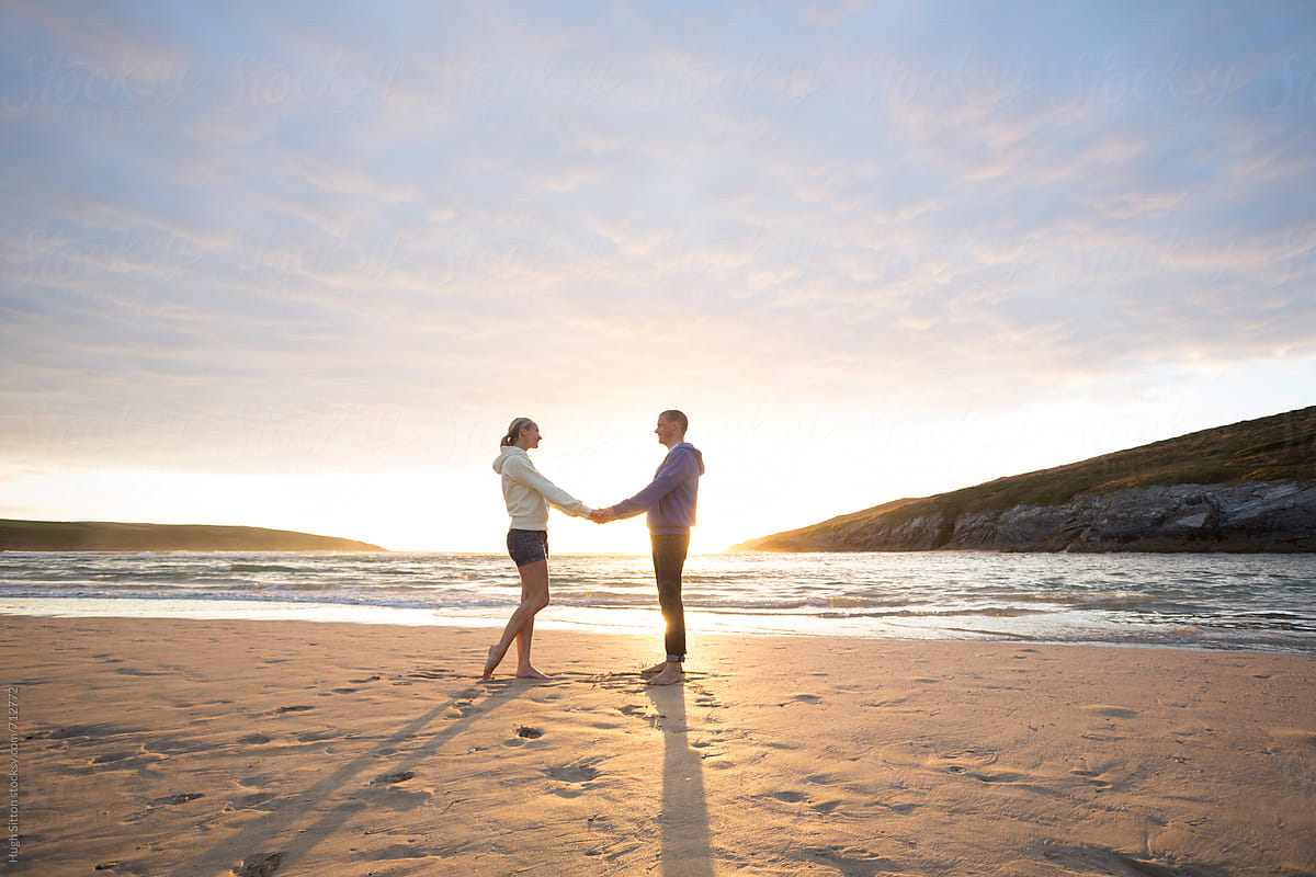 "Couple On Beach At Sunset." by Stocksy Contributor "Hugh Sitton" - Stocksy