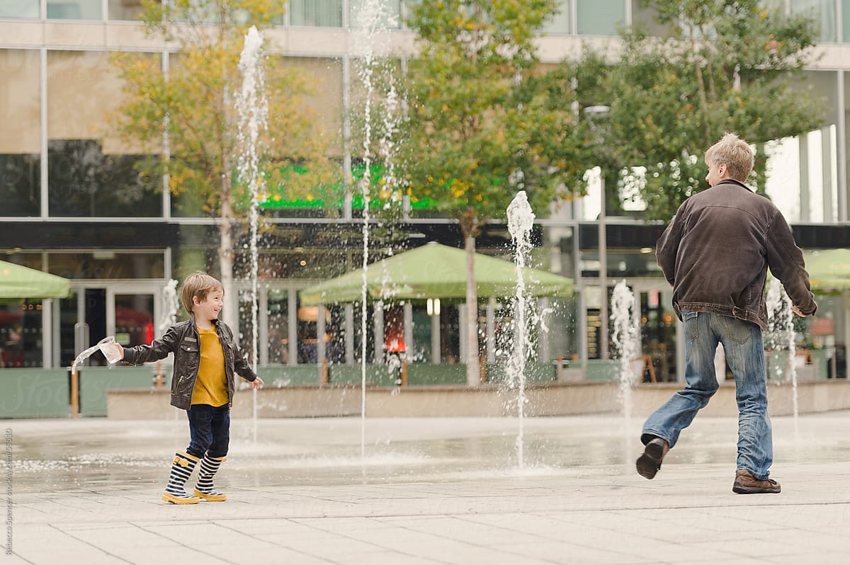 "Boy Throwing Water At Dad" by Stocksy Contributor "Rebecca Spencer ...