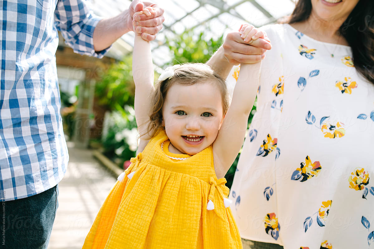 "Toddler Walk With Parents Holding Hands" by Stocksy Contributor "Maria ...