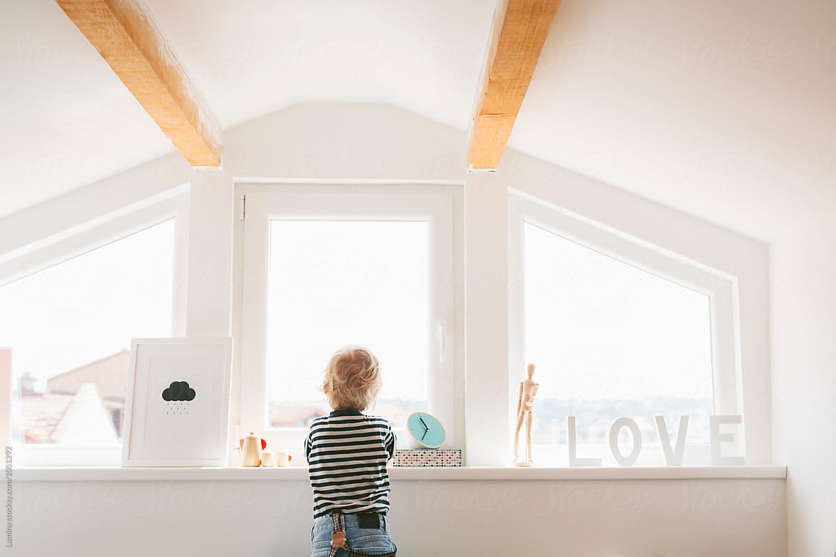 "Boy Standing By The Window" by Stocksy Contributor "Lumina" - Stocksy
