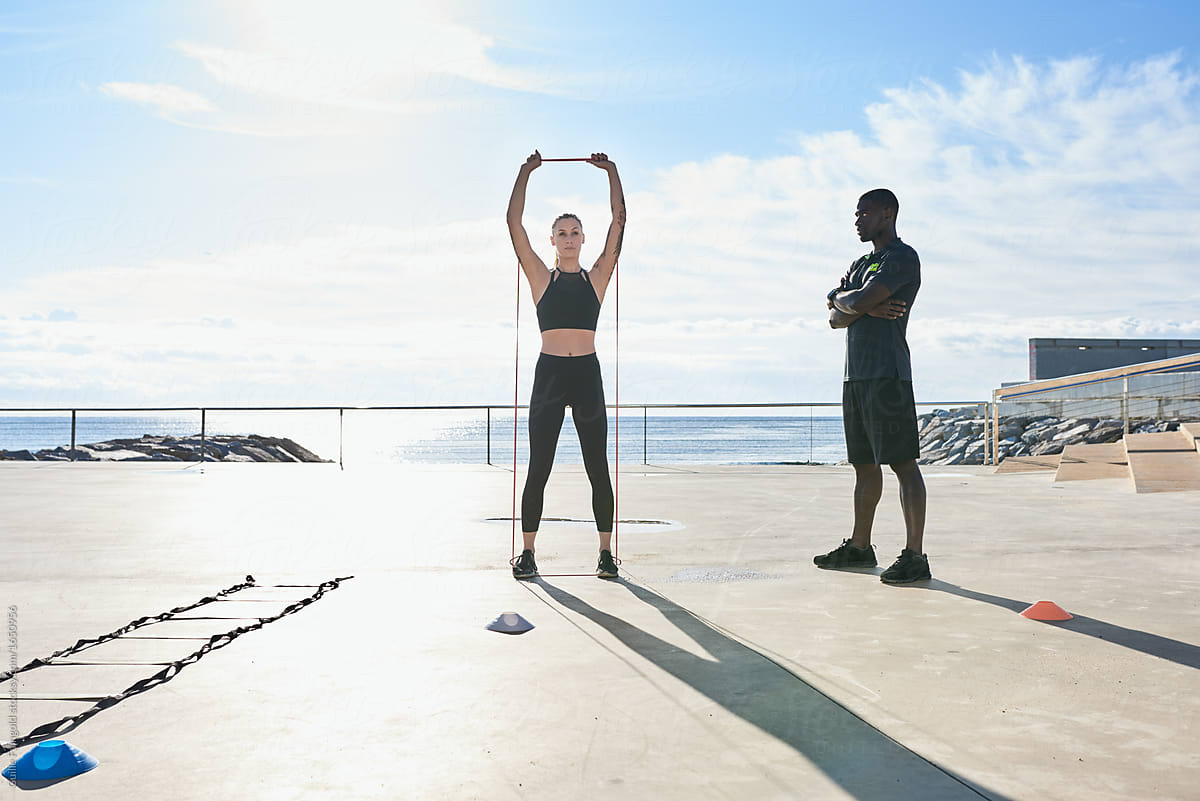 "Sportswoman Performing Exercising With Trainer." by Stocksy ...