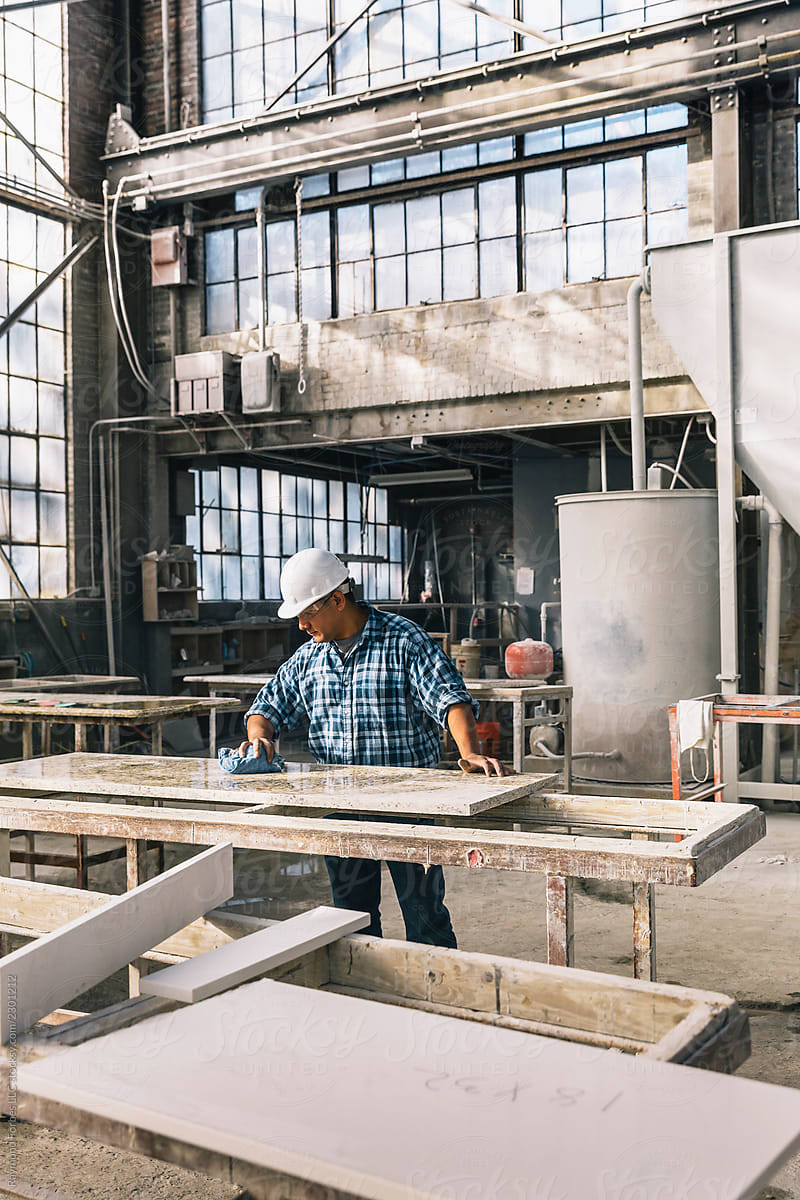 "Hispanic Man At Workplace" by Stocksy Contributor "Raymond Forbes LLC ...