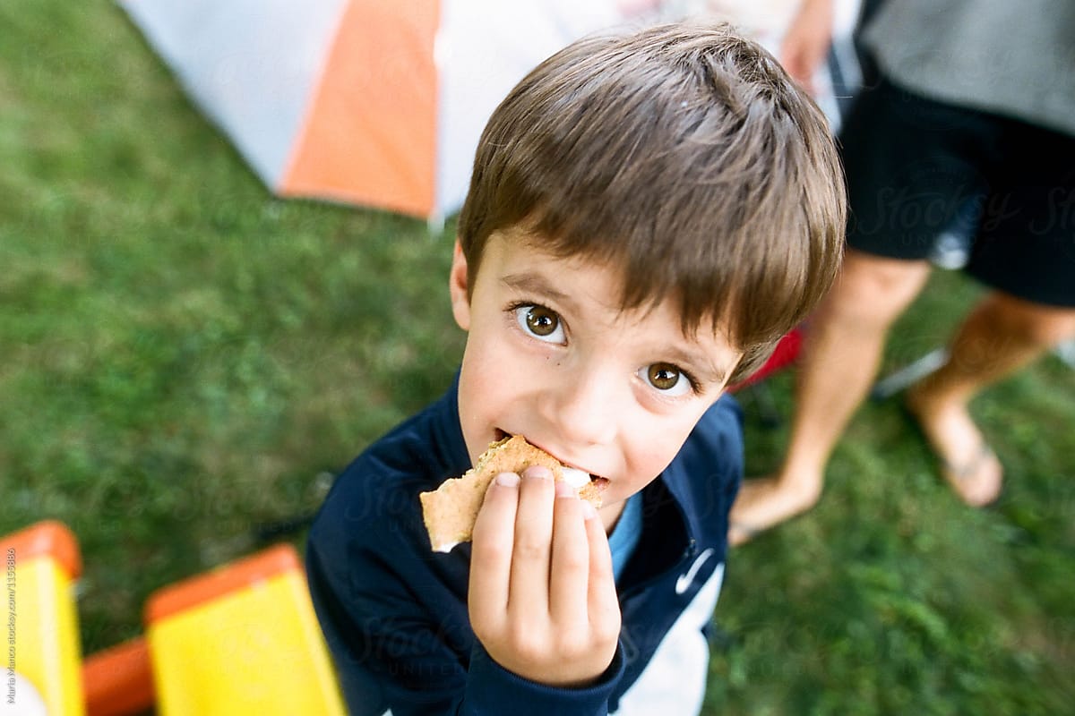 "Boy Makes S'mores" by Stocksy Contributor "Maria Manco" - Stocksy