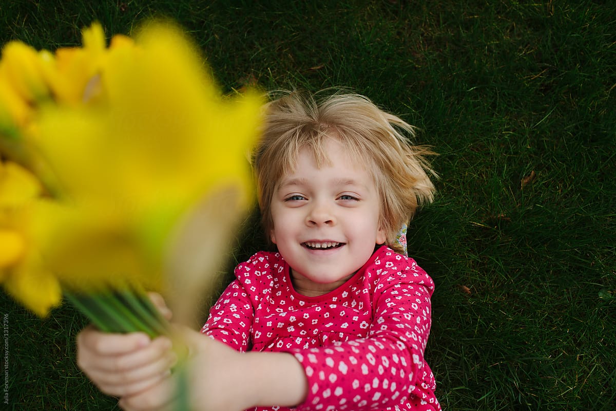"Happy Girl Waves Bright Yellow Daffodils." by Stocksy Contributor ...