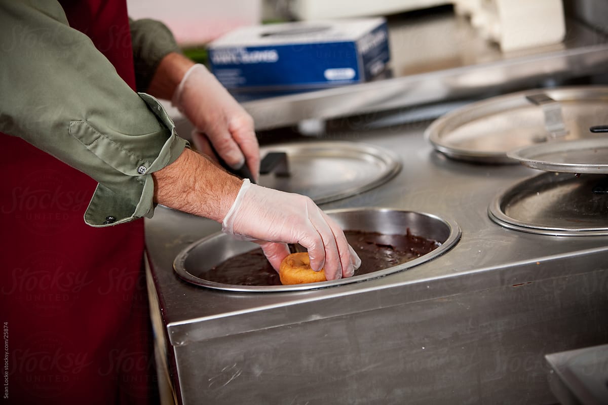 "Bakery: Man Dips Donut In Chocolate" by Stocksy Contributor "Sean ...