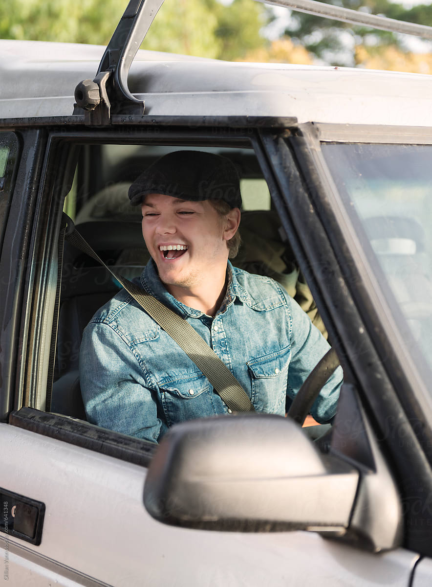 "Young Man Smiling And Laughing Out Of Car Window" by Stocksy ...