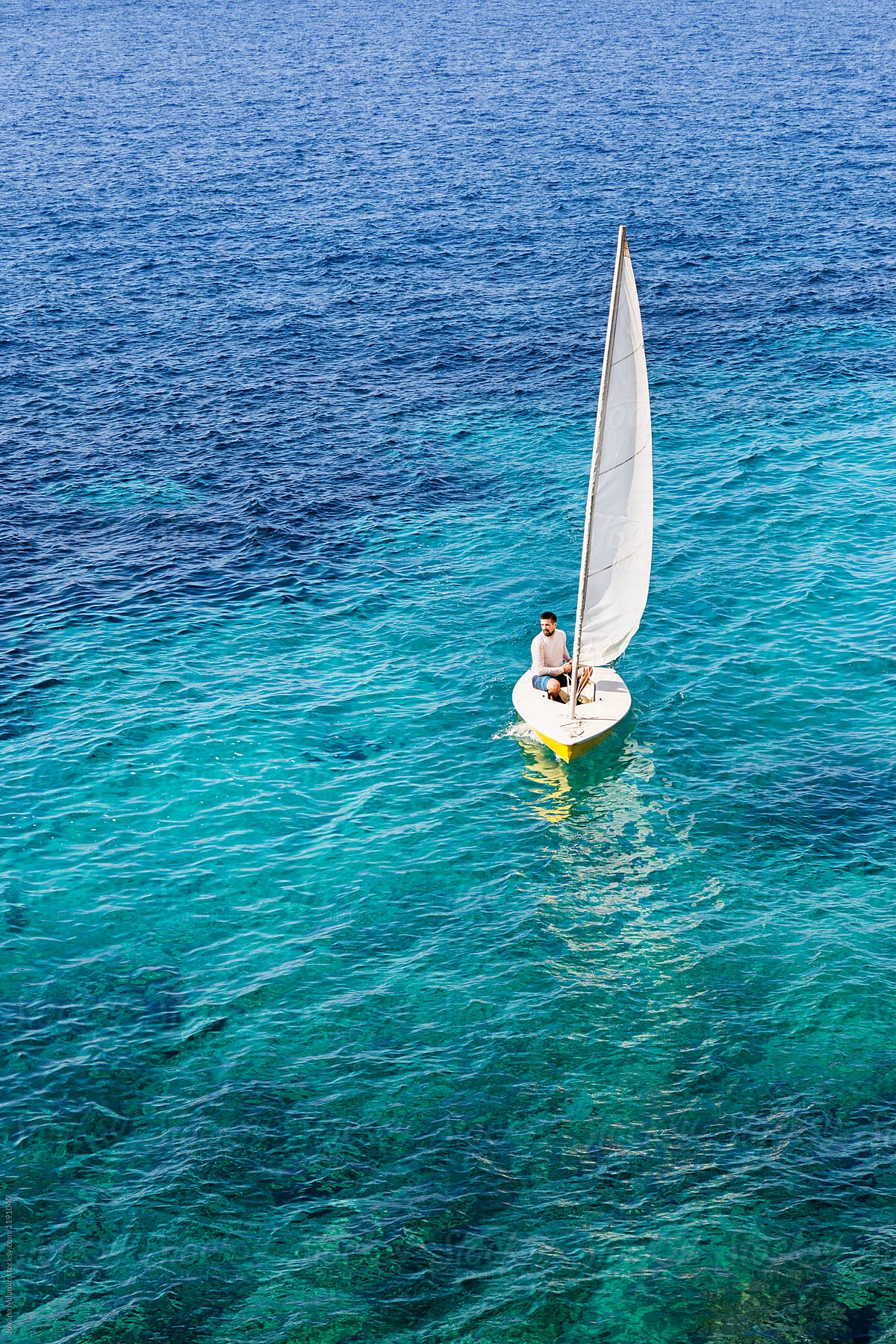 Man Sailing A Laser Sailboat Over The Blue Sea By Stocksy Contributor man-sailing-a-laser-sailboat-over-the-blue-sea-by-stocksy-contributor