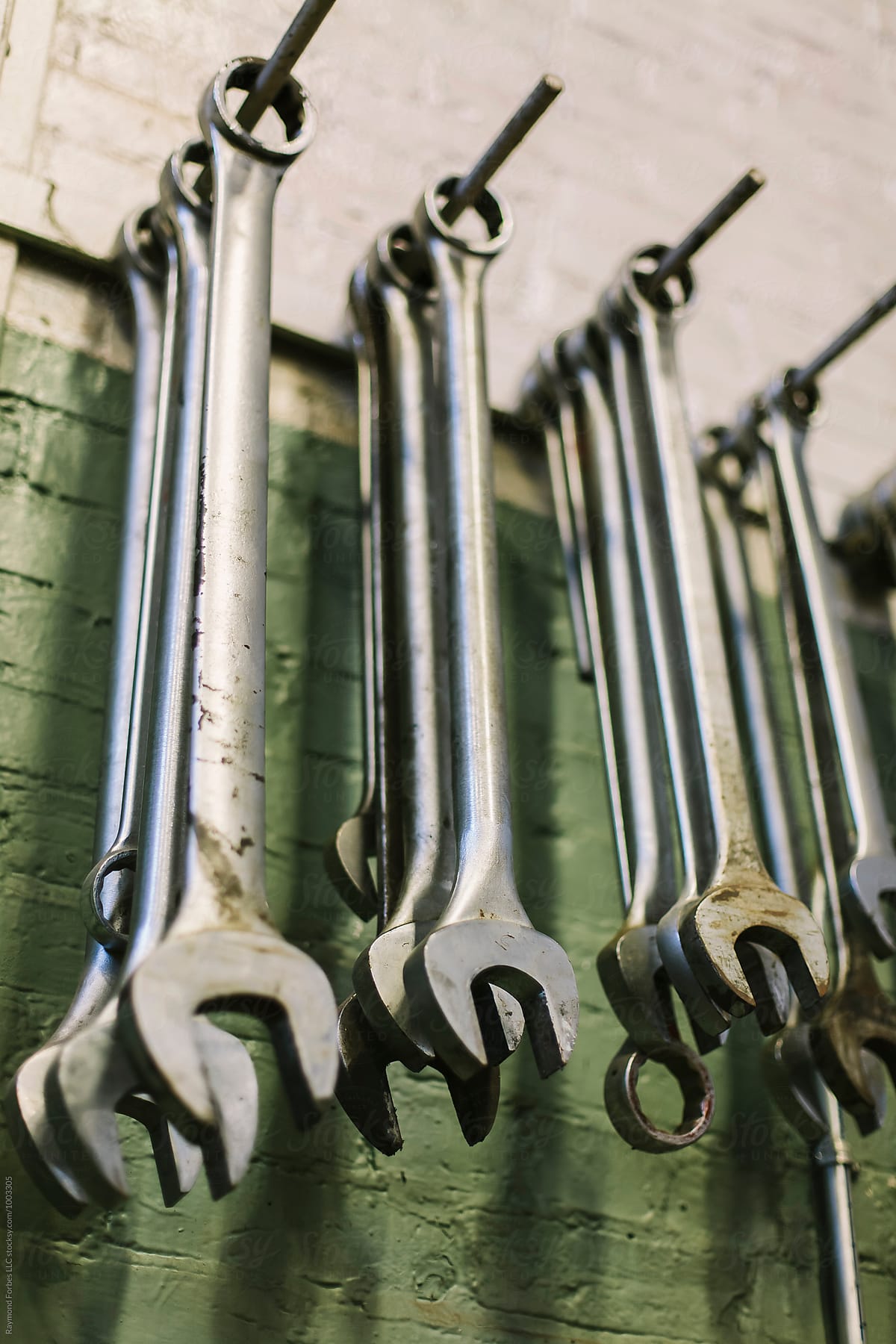 "Wrenches Hanging In The Garage" by Stocksy Contributor "Raymond Forbes ...