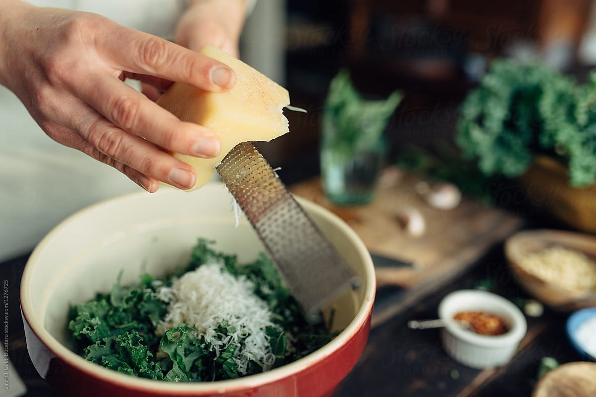 "Woman Grating Parmesan Cheese Into Kale Salad" by Stocksy Contributor ...