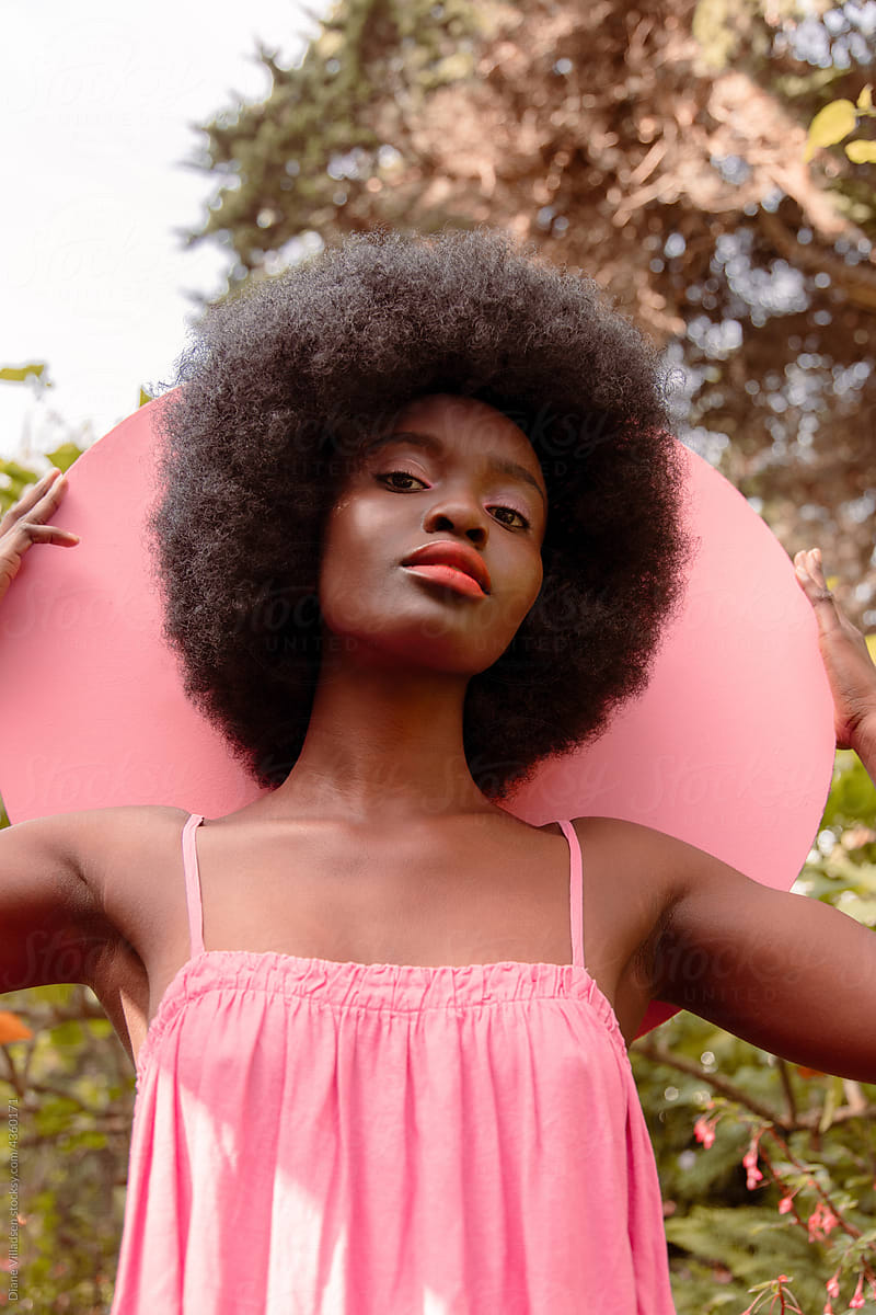 "Girl Poses With Pink Circle" by Stocksy Contributor "Diane Villadsen ...
